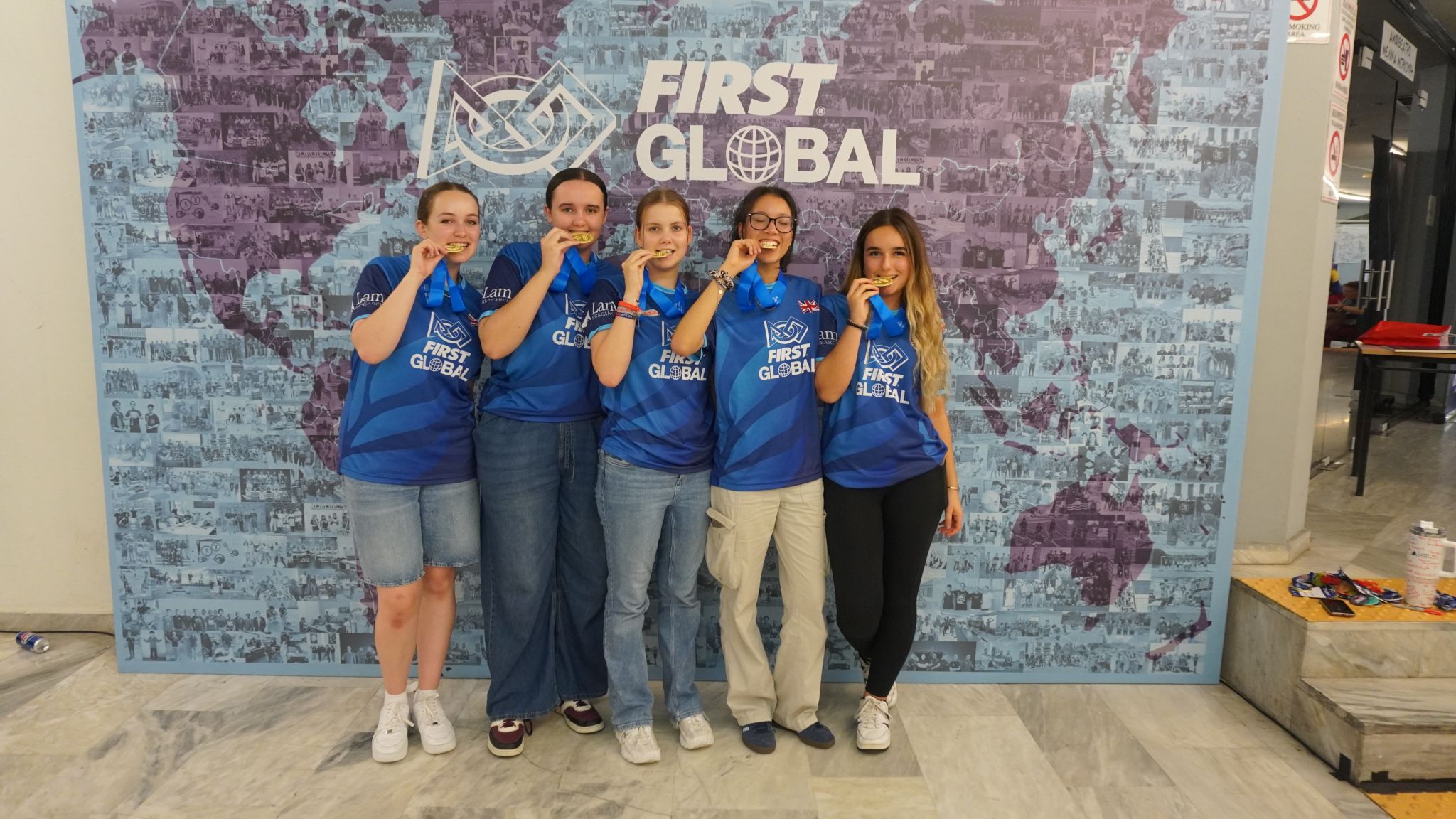 You can’t win gold without the classic “biting the gold medal” team photo!